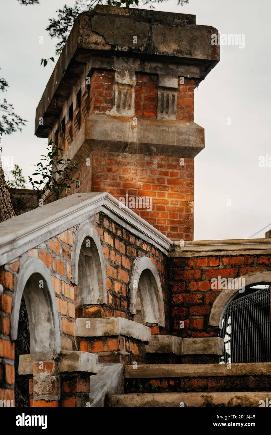 A close-up of an aged red brick building with unique architectural ...