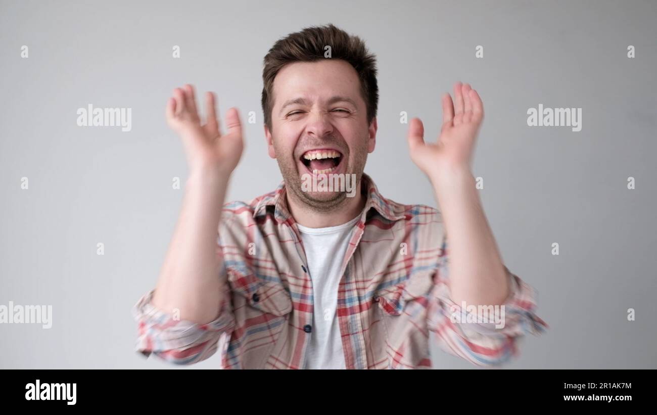 European young man is laughing loudly. Studio shot Stock Photo - Alamy