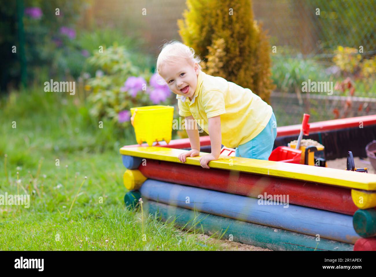 Child in sand box. Kid playing with sand on colorful playground. Active ...