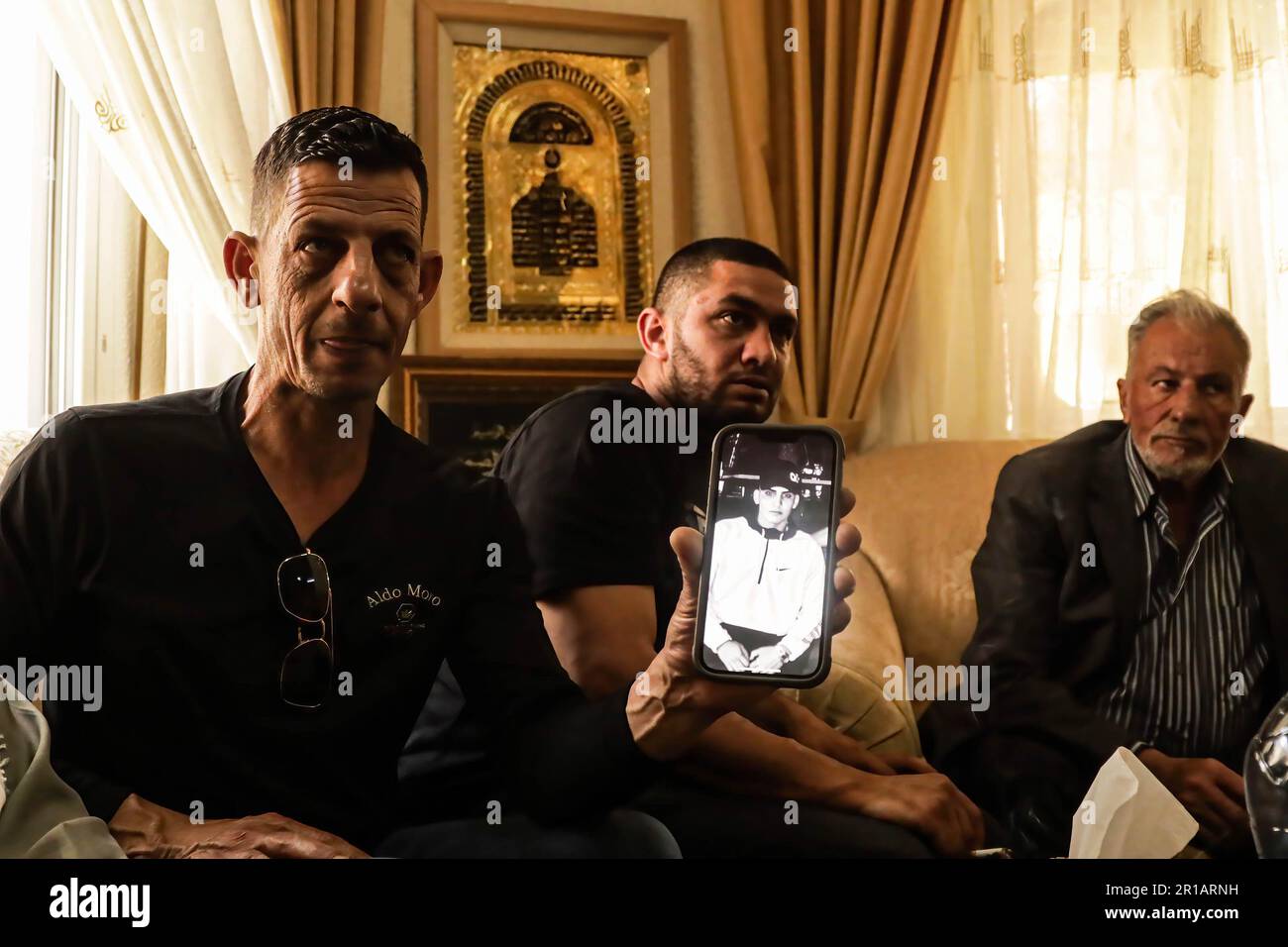 The father of the young Thaer Bakirat (Shehadeh Bakirat) shows the ...