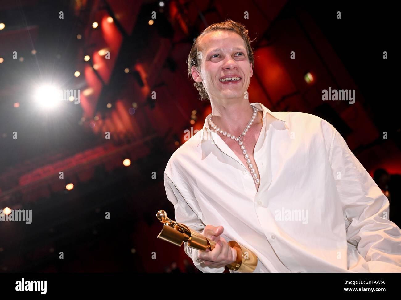 Berlin, Germany. 12th May, 2023. Felix Kammerer, actor, holds the award ...