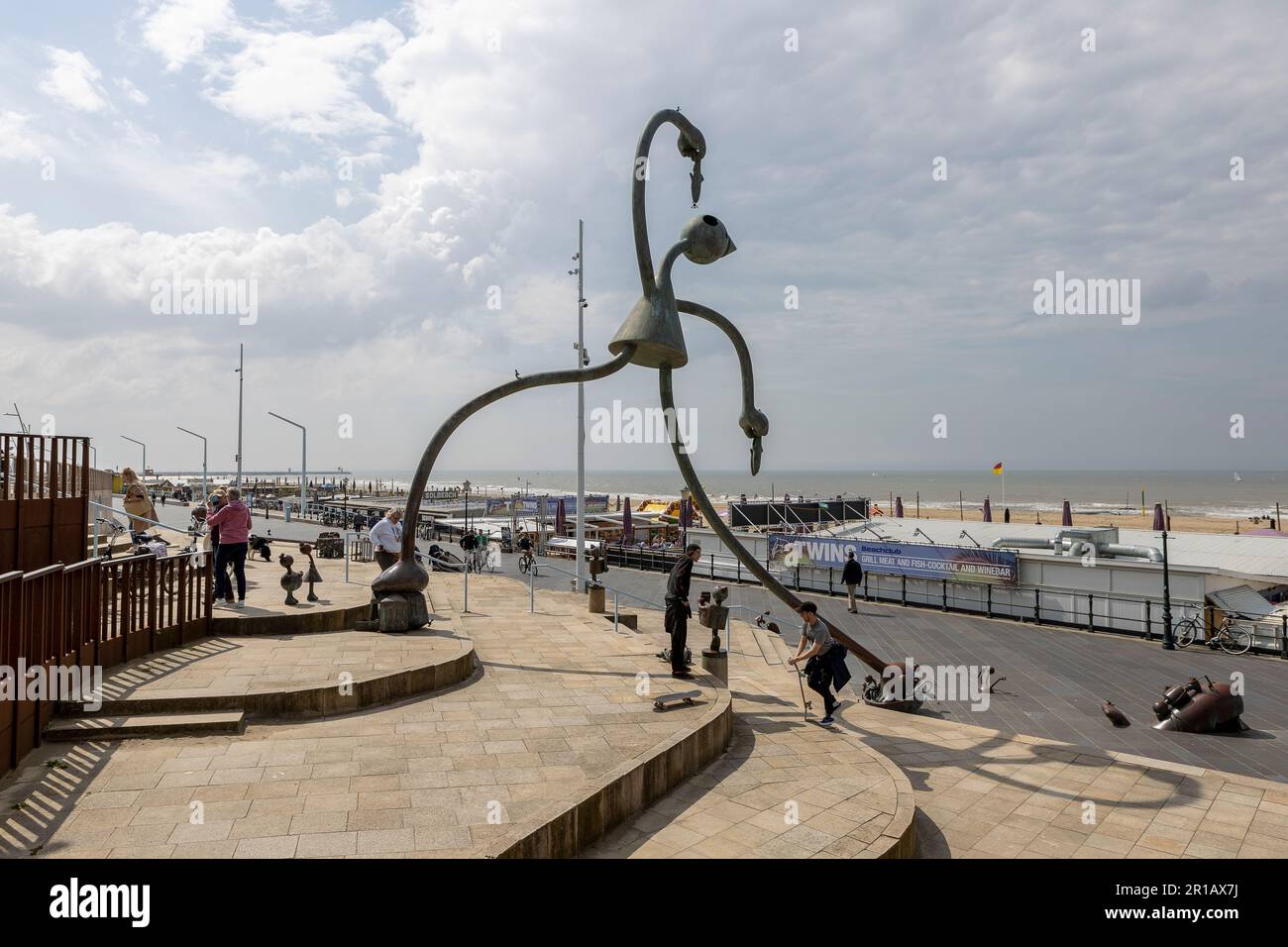 Bronze street art sculpture statues in different sizes on seaside beach ...