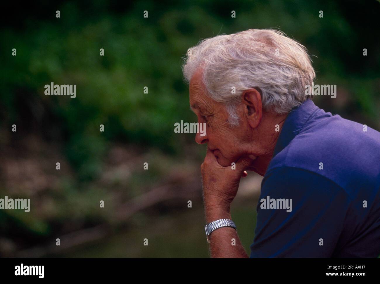 An older man sitting and thinking deeply in the evening light, Missouri ...
