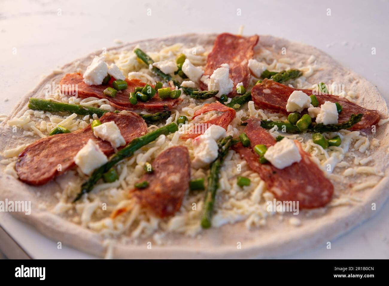 An italian pizza just topped and not cooked Stock Photo - Alamy
