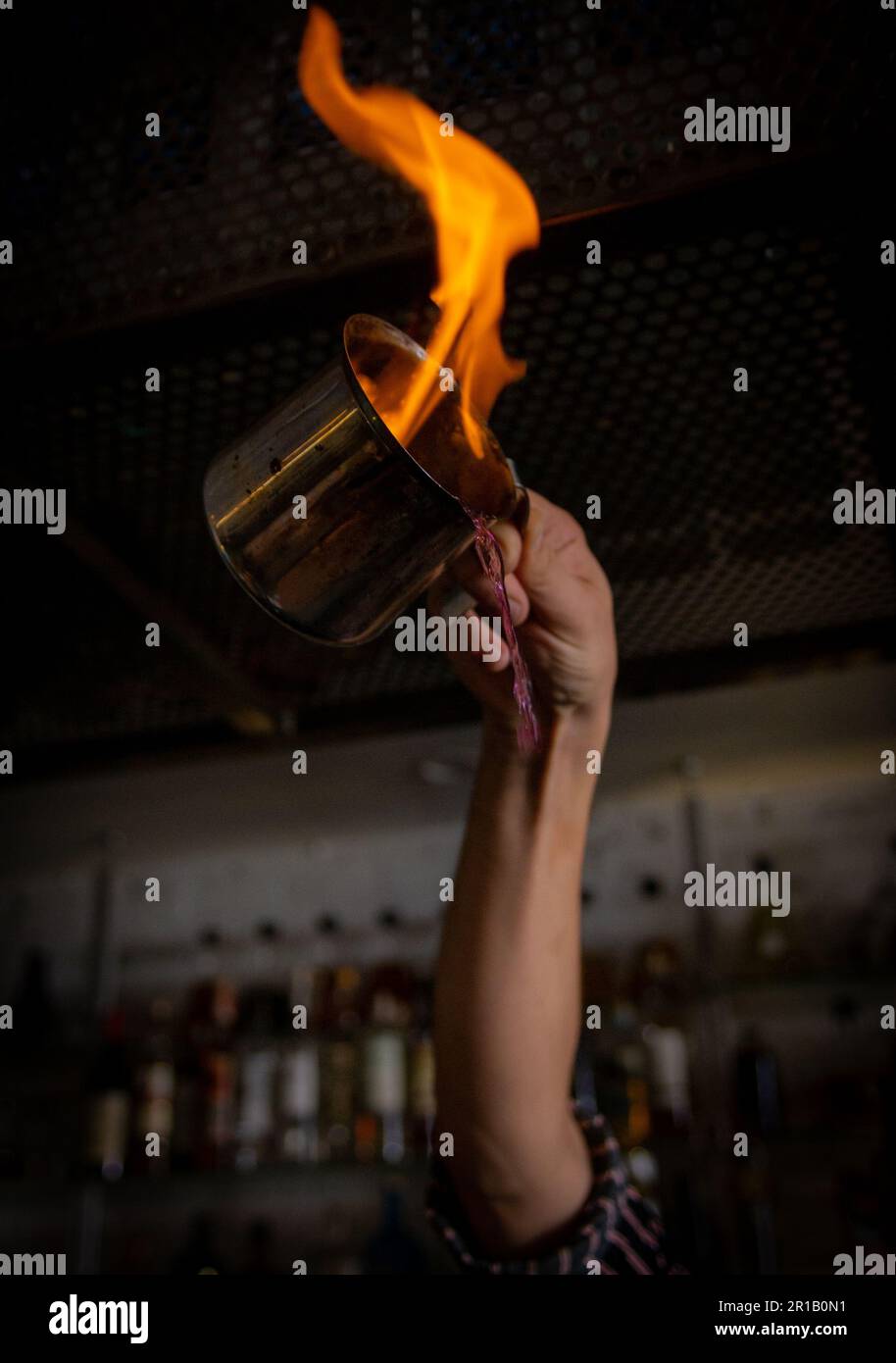 flare bartender pouring the alcohol on fire Stock Photo - Alamy