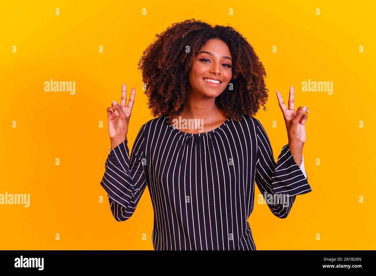 afro woman making V sign with hands. Happy afro girl with good vibe ...