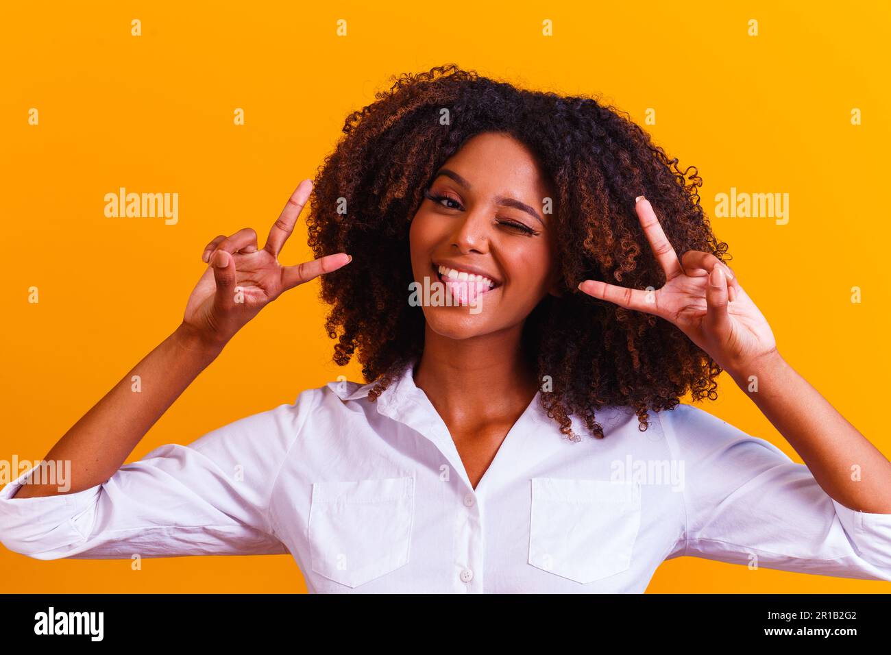afro woman making V sign with hands. Happy afro girl with good vibe ...