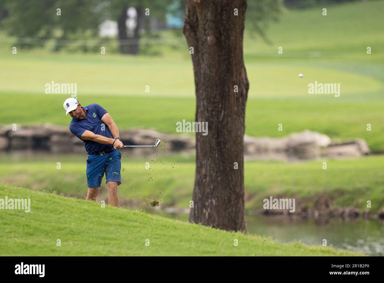 Dean Burmester of Stinger GC hits out of the rough on the eighth hole ...