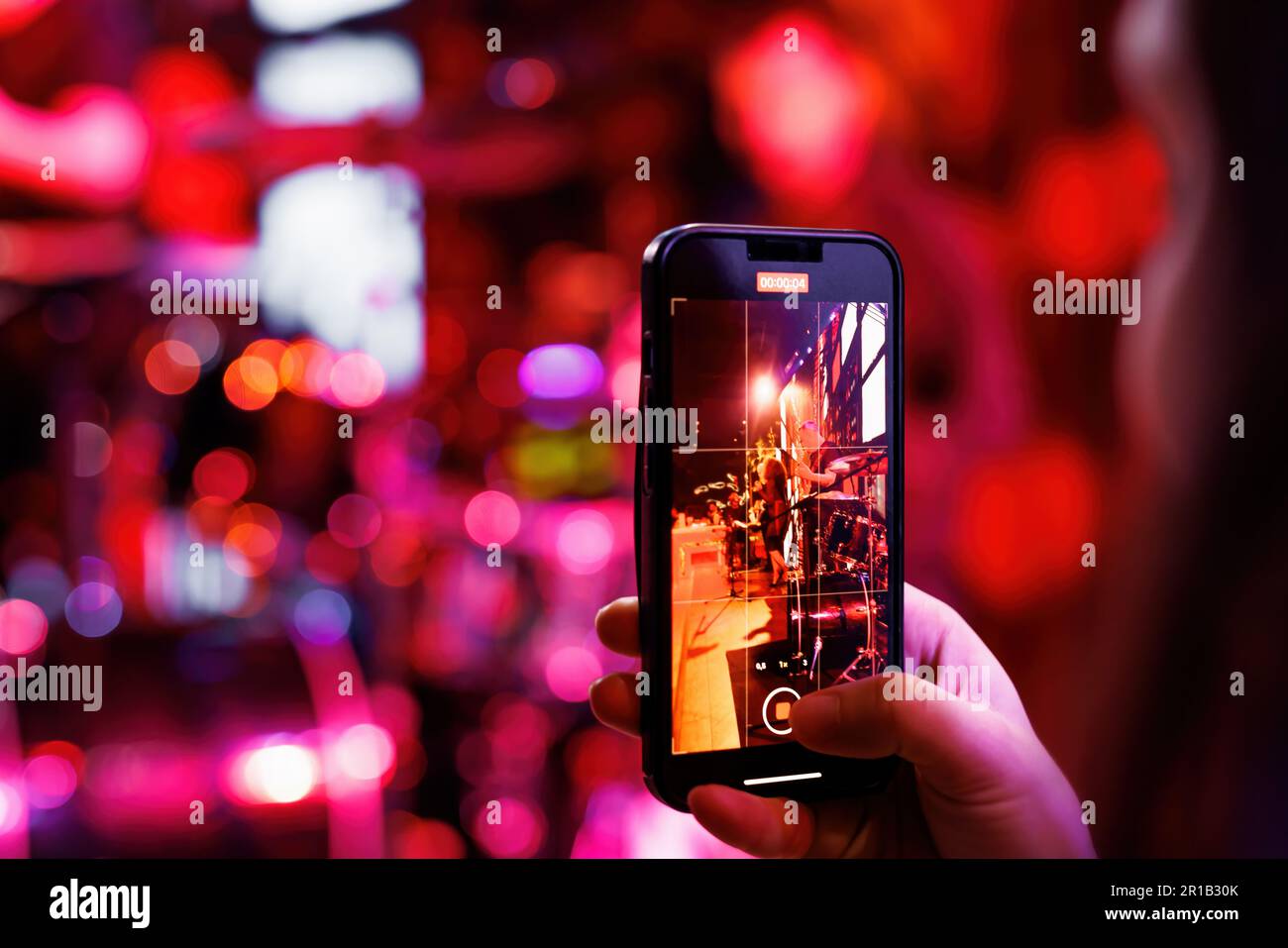 Using a smartphone for filming concert party Stock Photo - Alamy