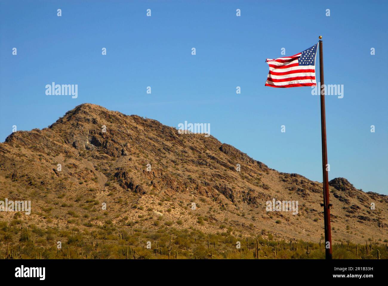Dramatic desert mountains with an American flag flying Stock Photo - Alamy