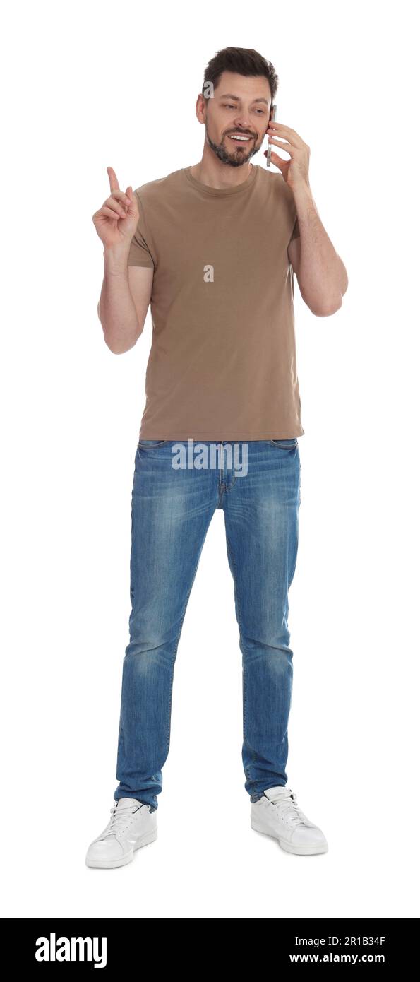 Man talking on phone against white background Stock Photo - Alamy