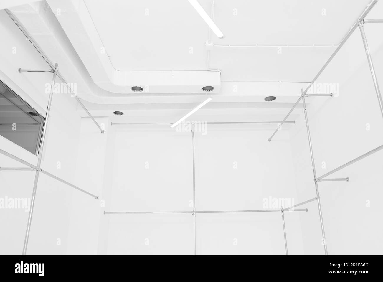 Empty room with beautiful white walls and garment racks during repair ...
