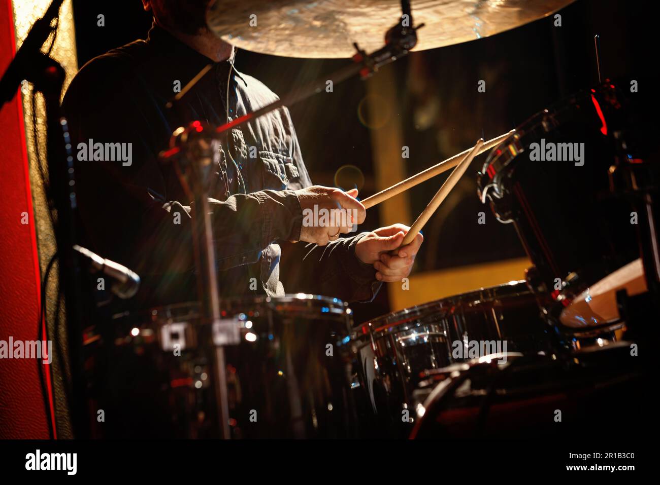 Close-up of drummer drumsticks with a drum set Stock Photo - Alamy