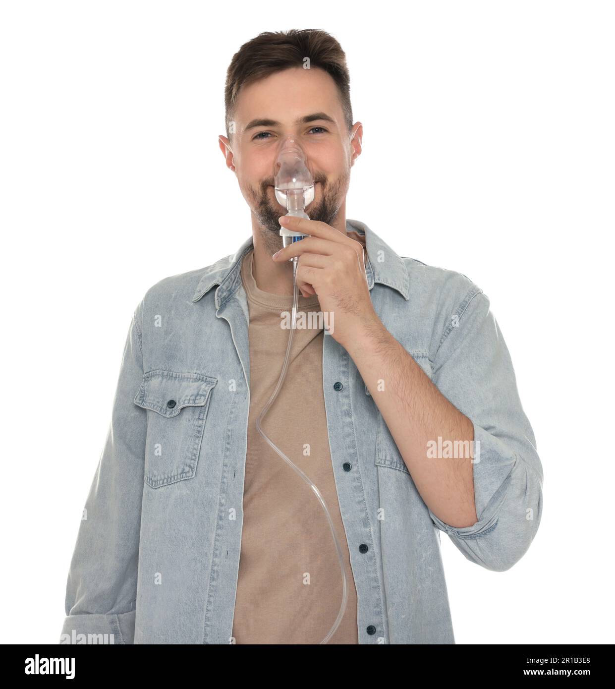 Man using nebulizer for inhalation on white background Stock Photo - Alamy