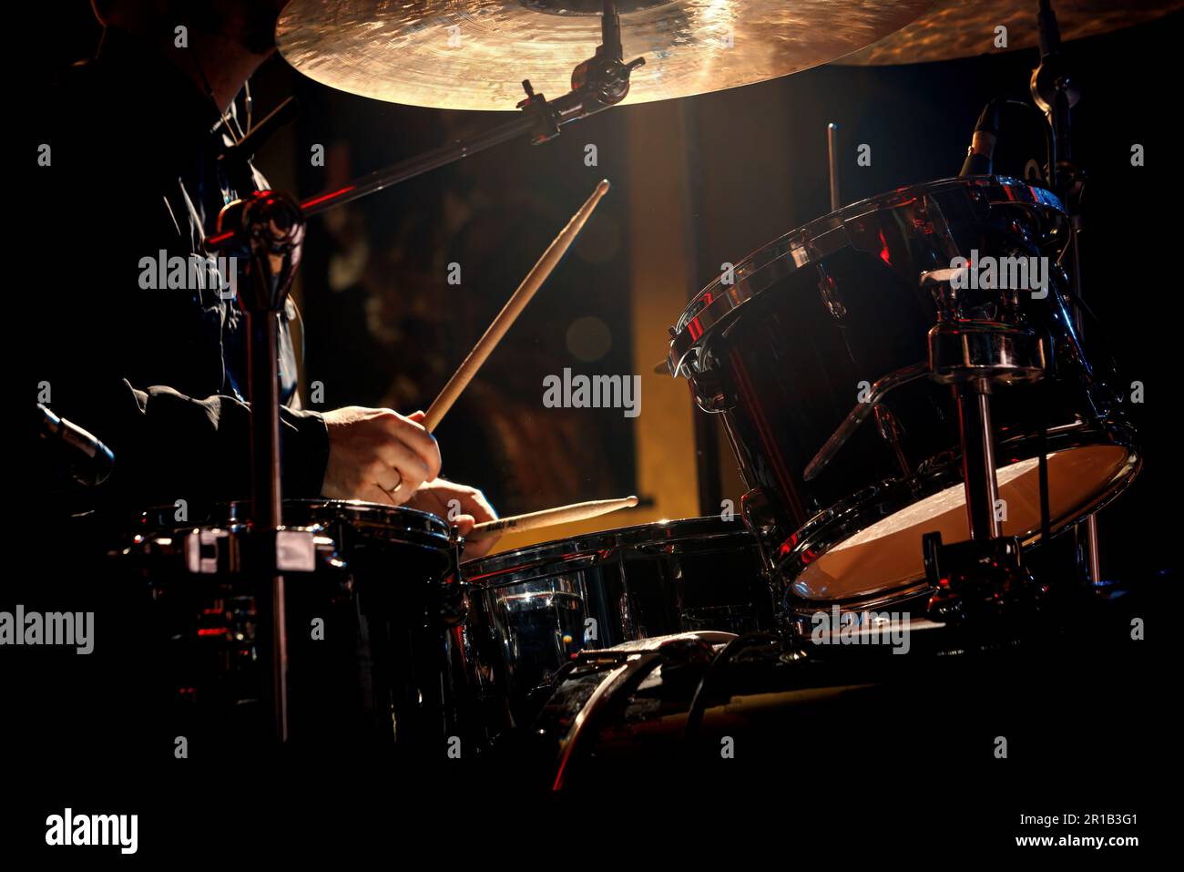 Drummer playing with drumsticks on a rock drum set Stock Photo - Alamy