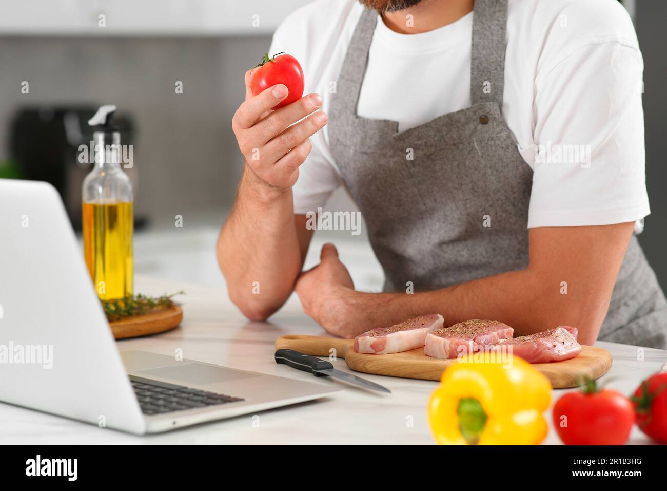 Man in kitchen holding steak hi-res stock photography and images - Alamy