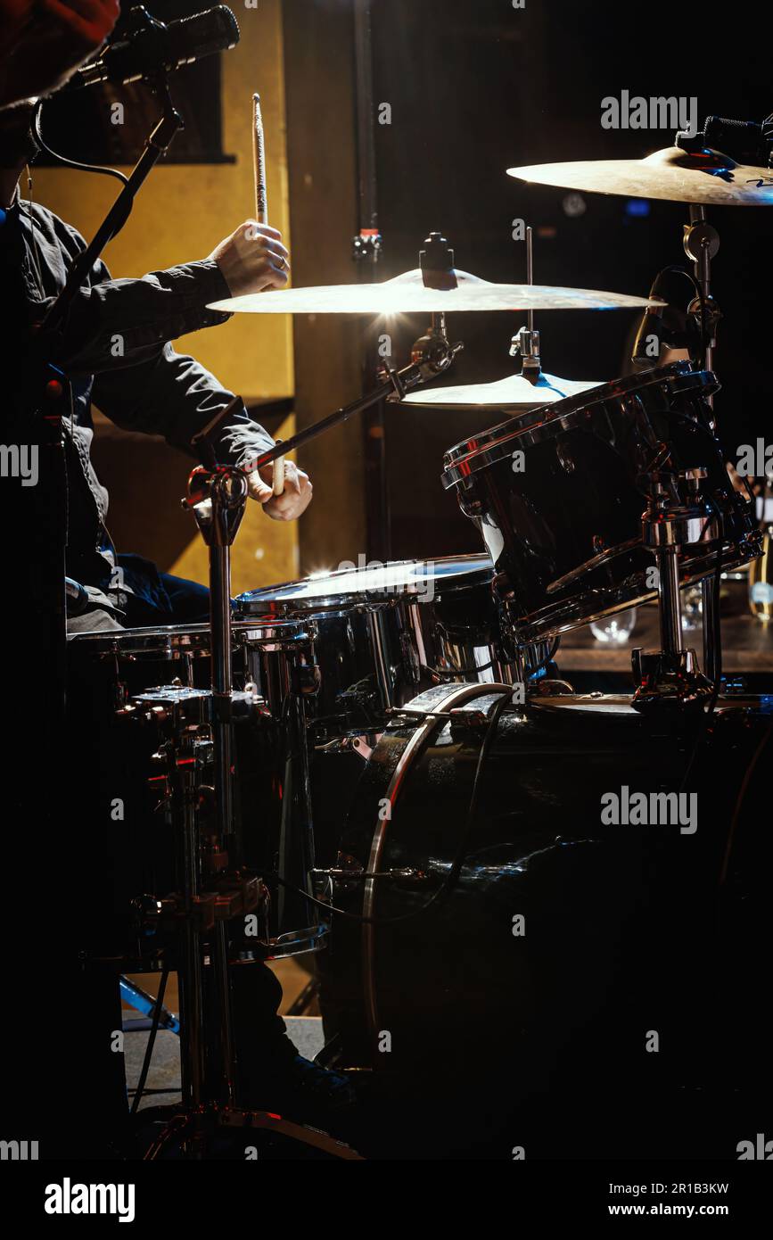 Percussionist performing on rock drum set with drumsticks Stock Photo ...
