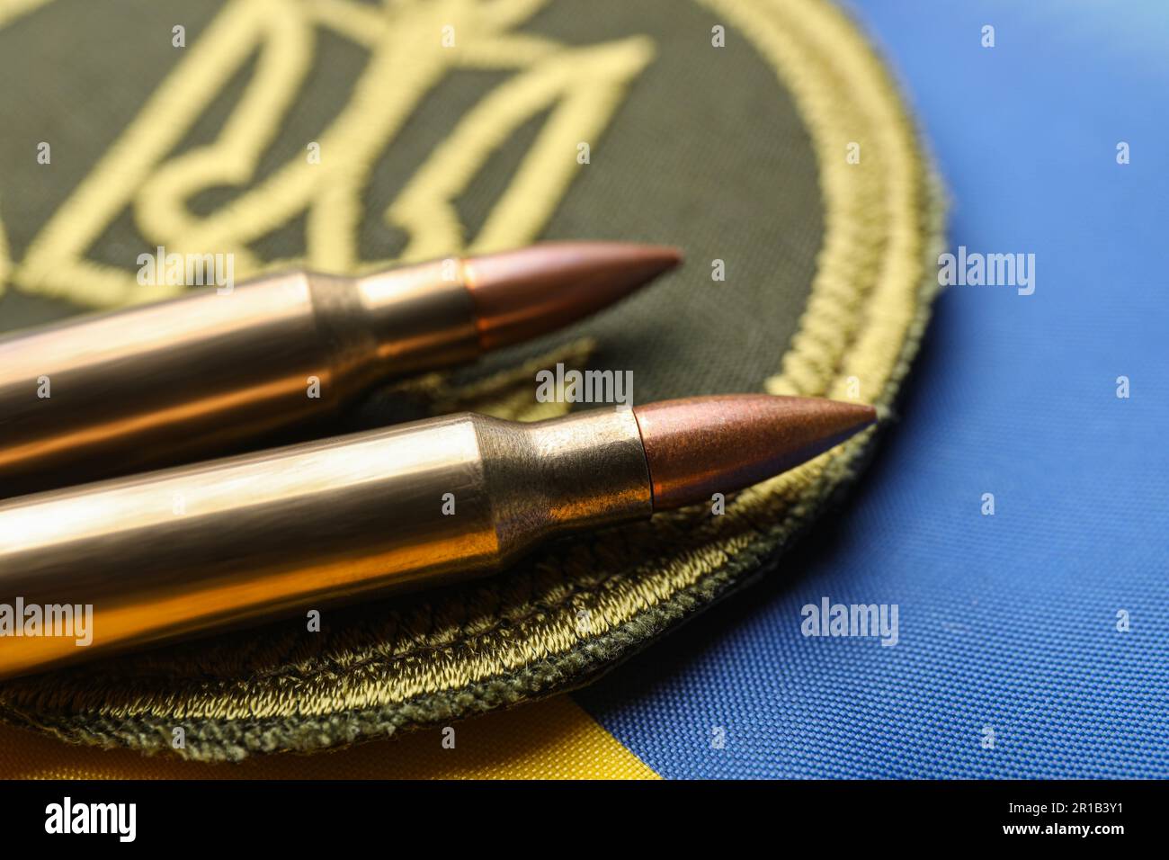 Bullets and military patch on Ukrainian flag, closeup Stock Photo - Alamy