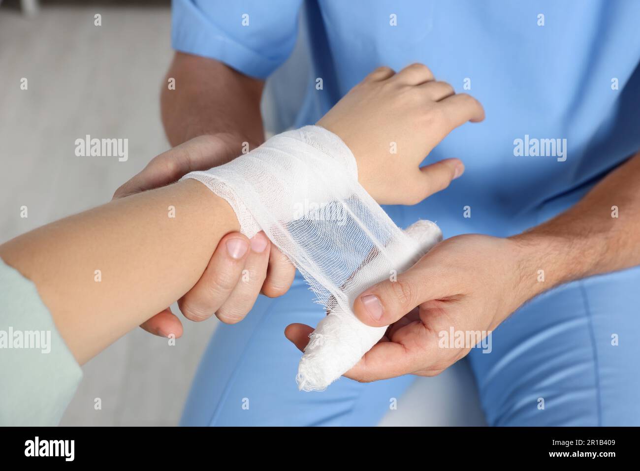 Doctor applying bandage onto patient's wrist in hospital, closeup Stock ...