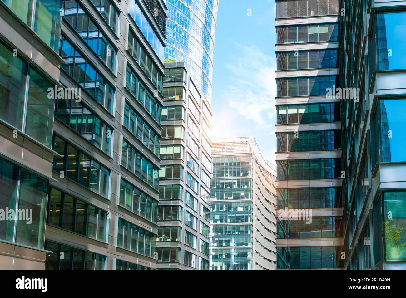 Stylish buildings with many windows under cloudy sky Stock Photo - Alamy