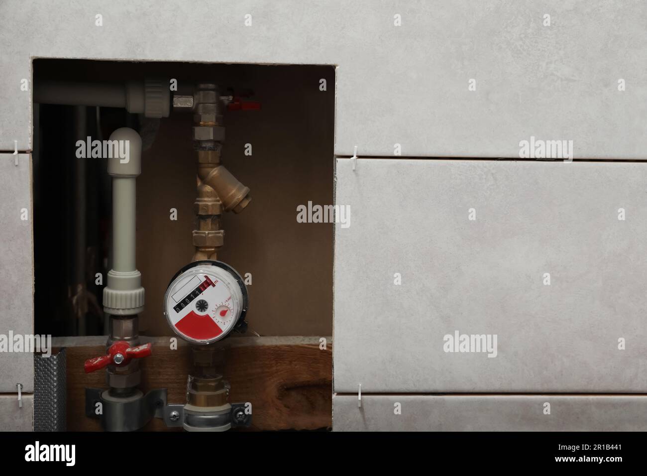 Water meter and ceramic tiles with spacers on wall Stock Photo - Alamy