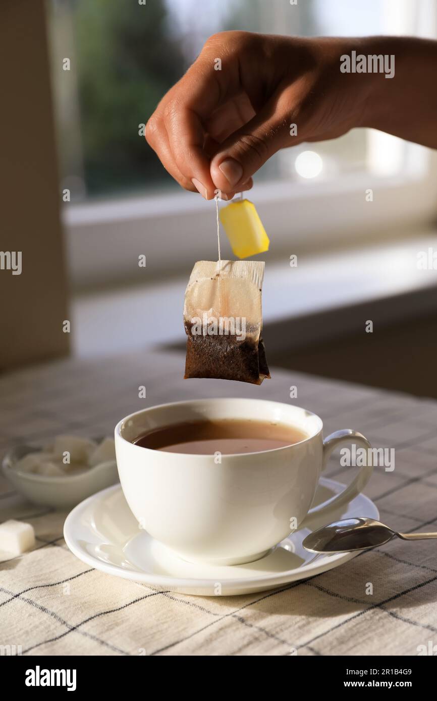 Woman taking tea bag hi-res stock photography and images - Alamy