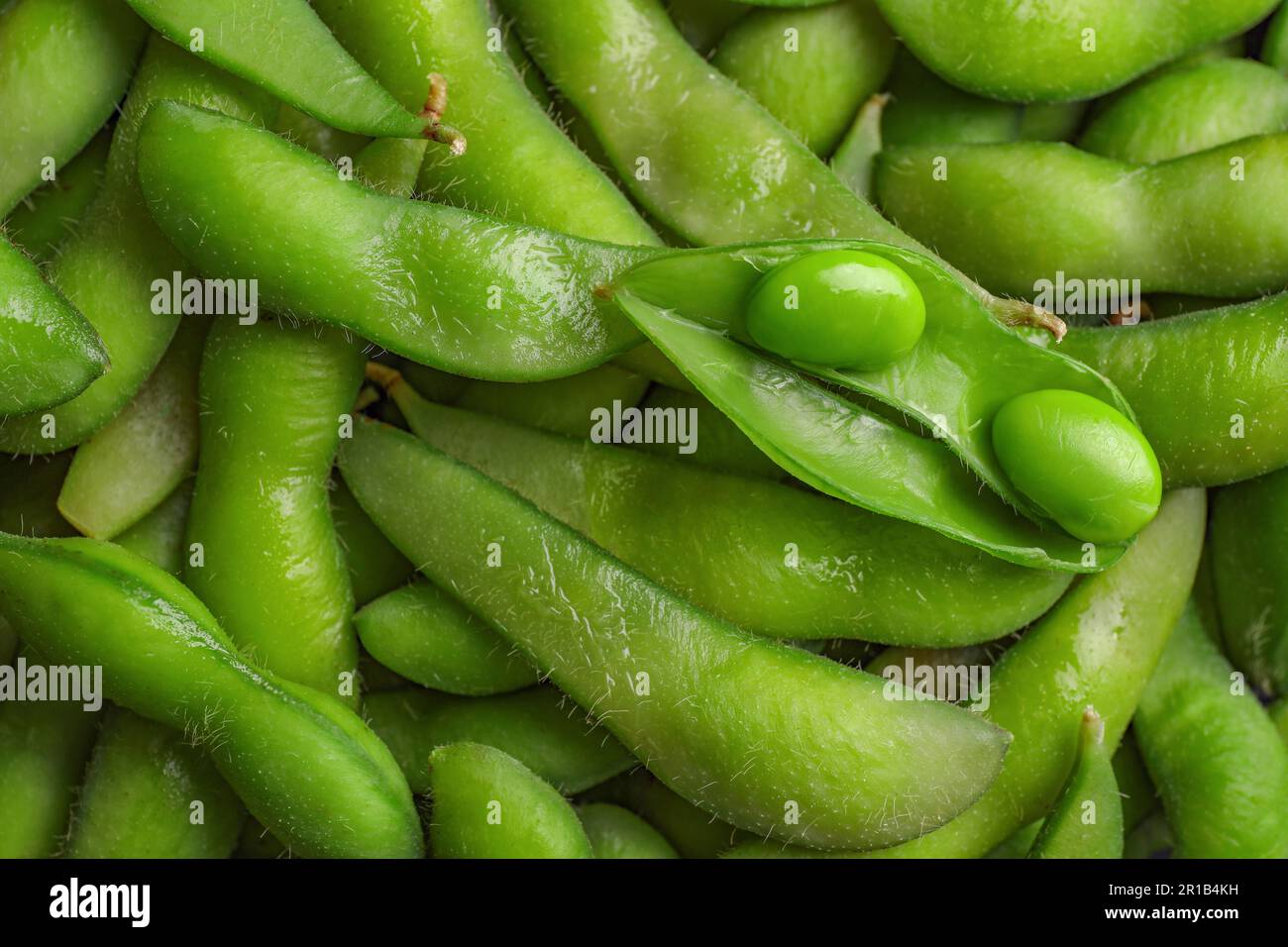 Many green edamame beans in pods as background, closeup Stock Photo - Alamy