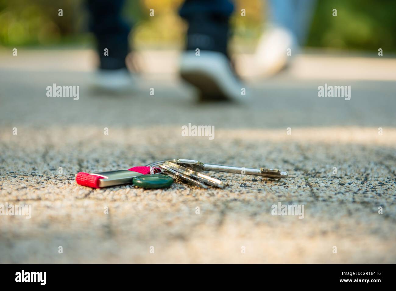 Men walking outside, focus on lost keys Stock Photo - Alamy