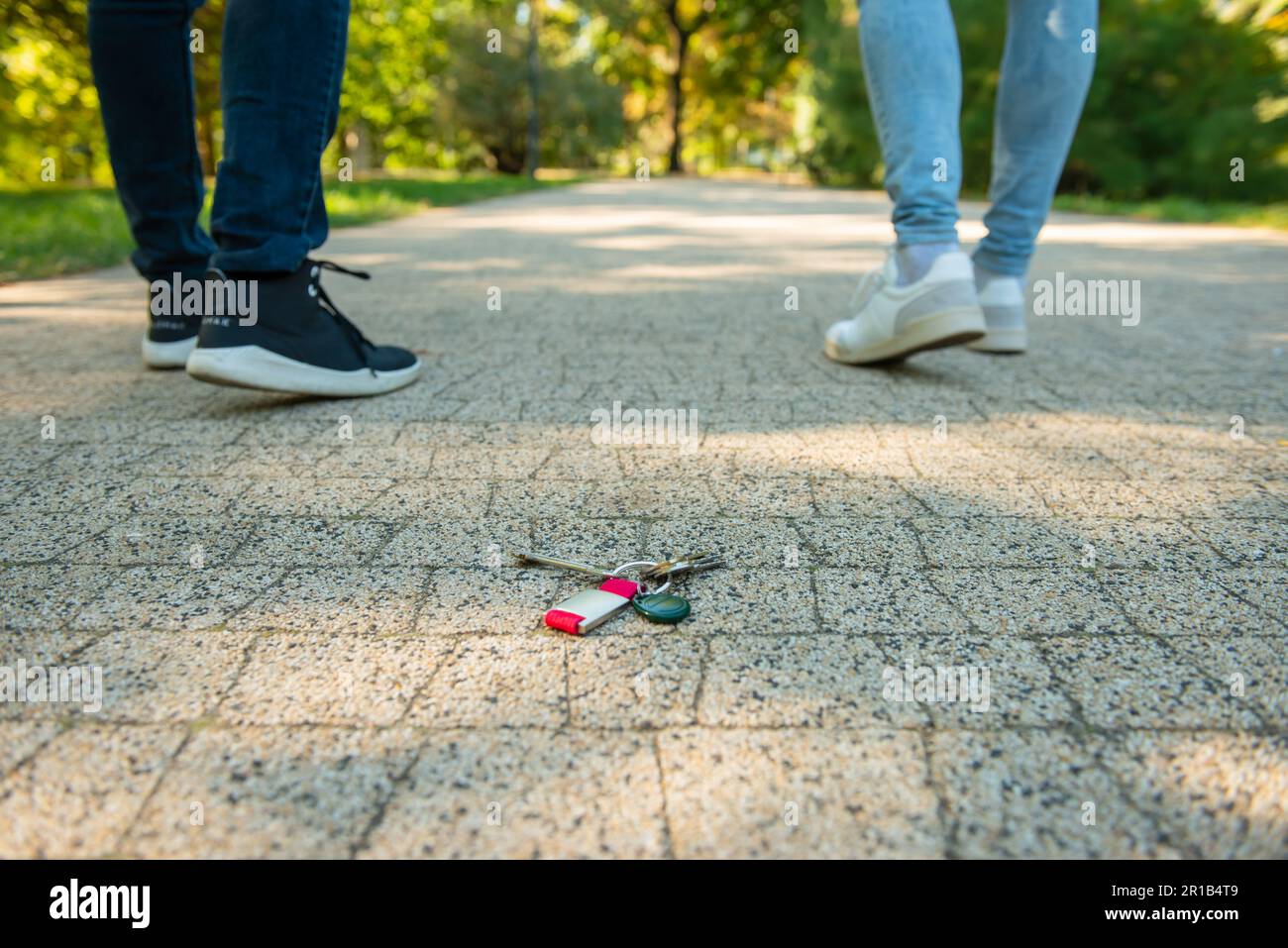 Men walking outside, focus on lost keys Stock Photo - Alamy