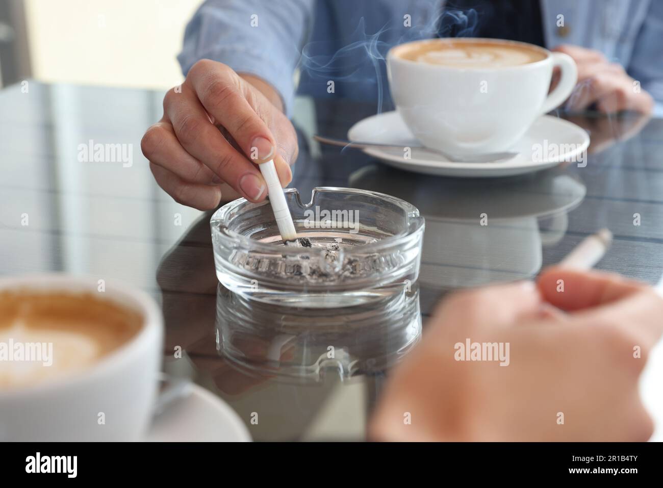 Putting out cigarette hi-res stock photography and images - Alamy