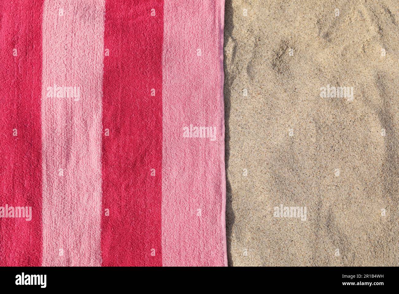 Soft pink beach towel on sand, top view. Space for text Stock Photo - Alamy