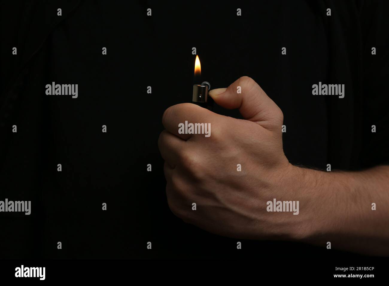 Man holding lighter on black background, closeup. Space for text Stock ...