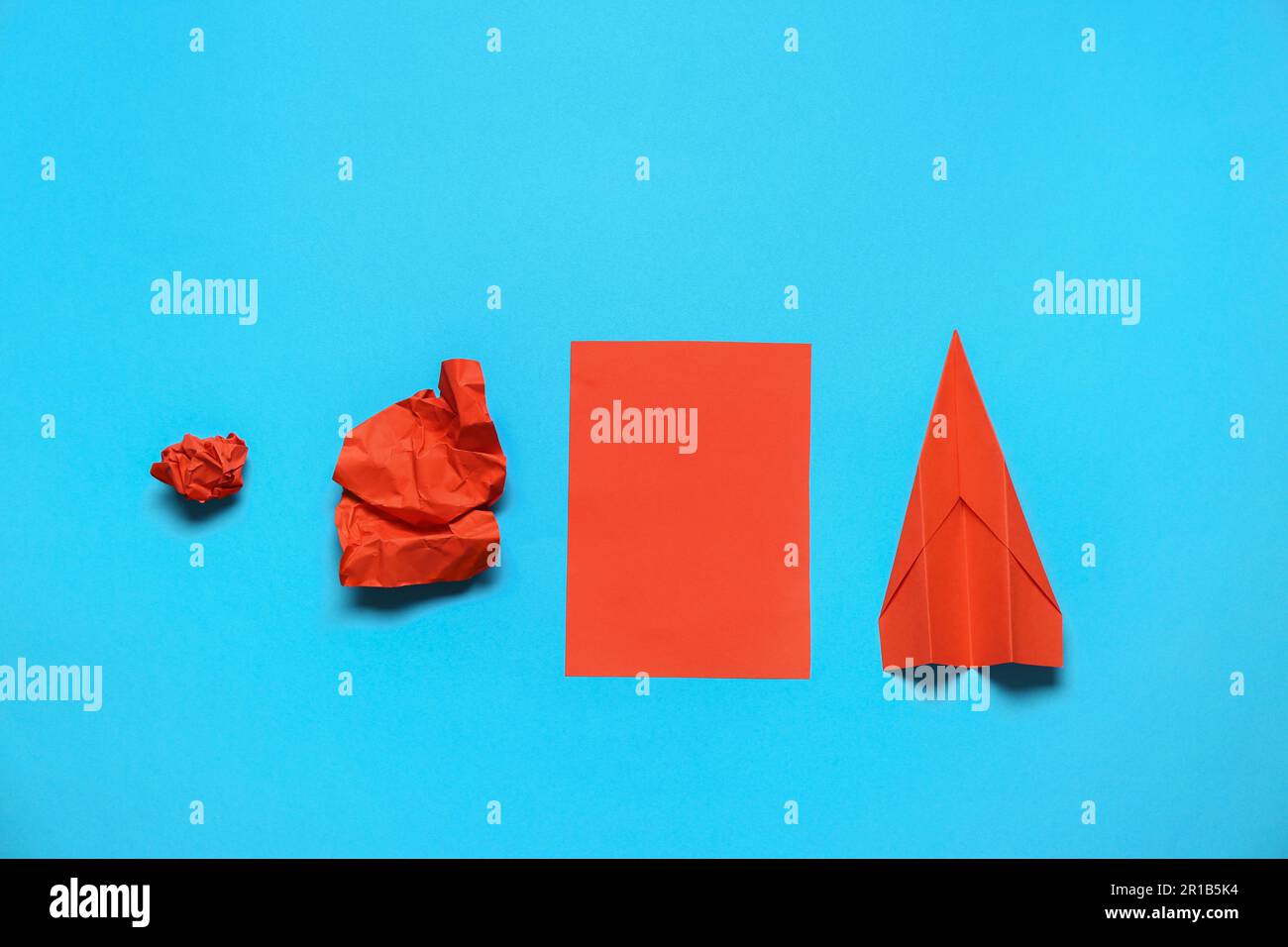 Making paper plane, trial and error. Flat lay composition with crumpled ...