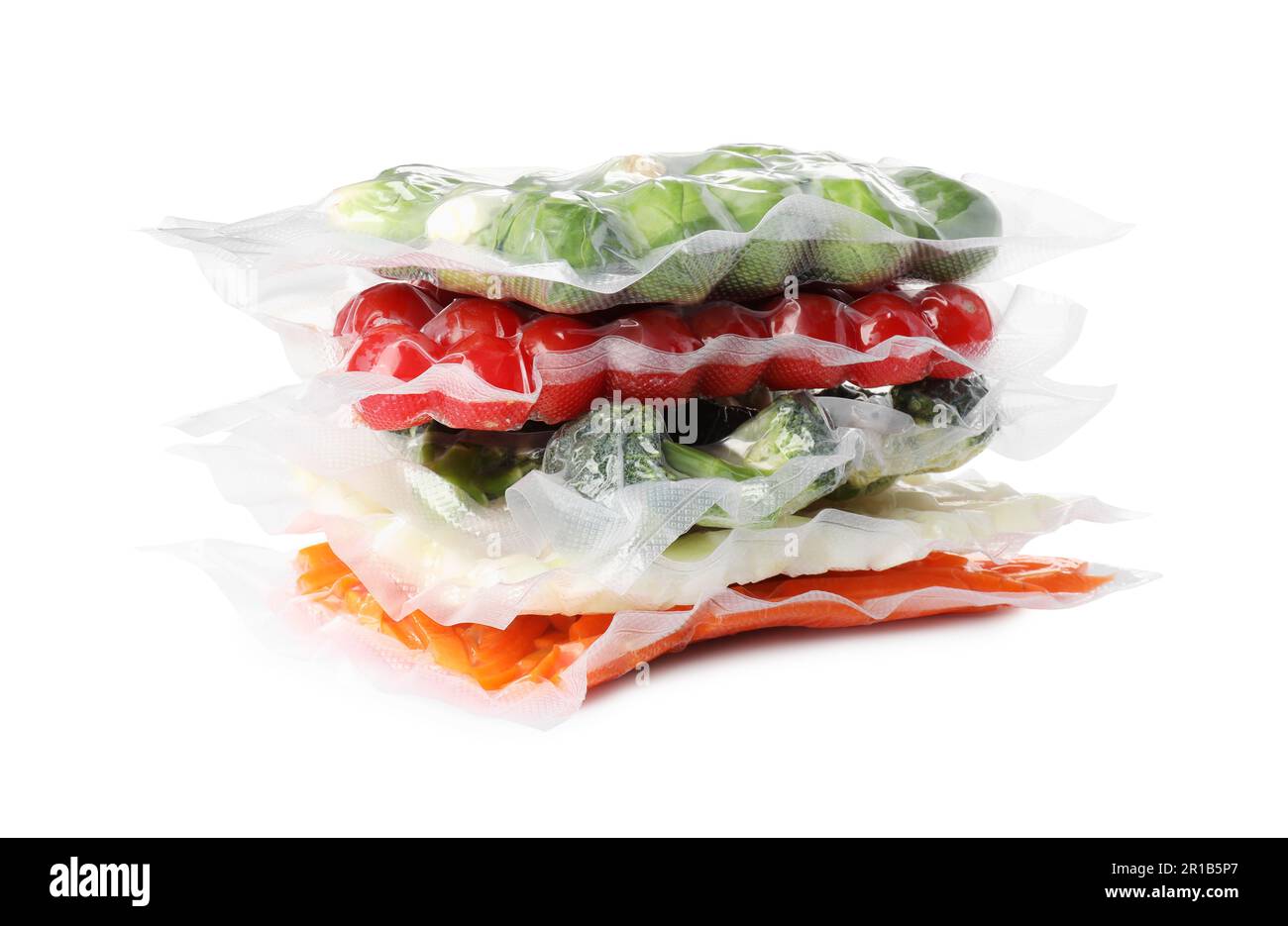 Stack of vacuum packs with different food products on white background ...