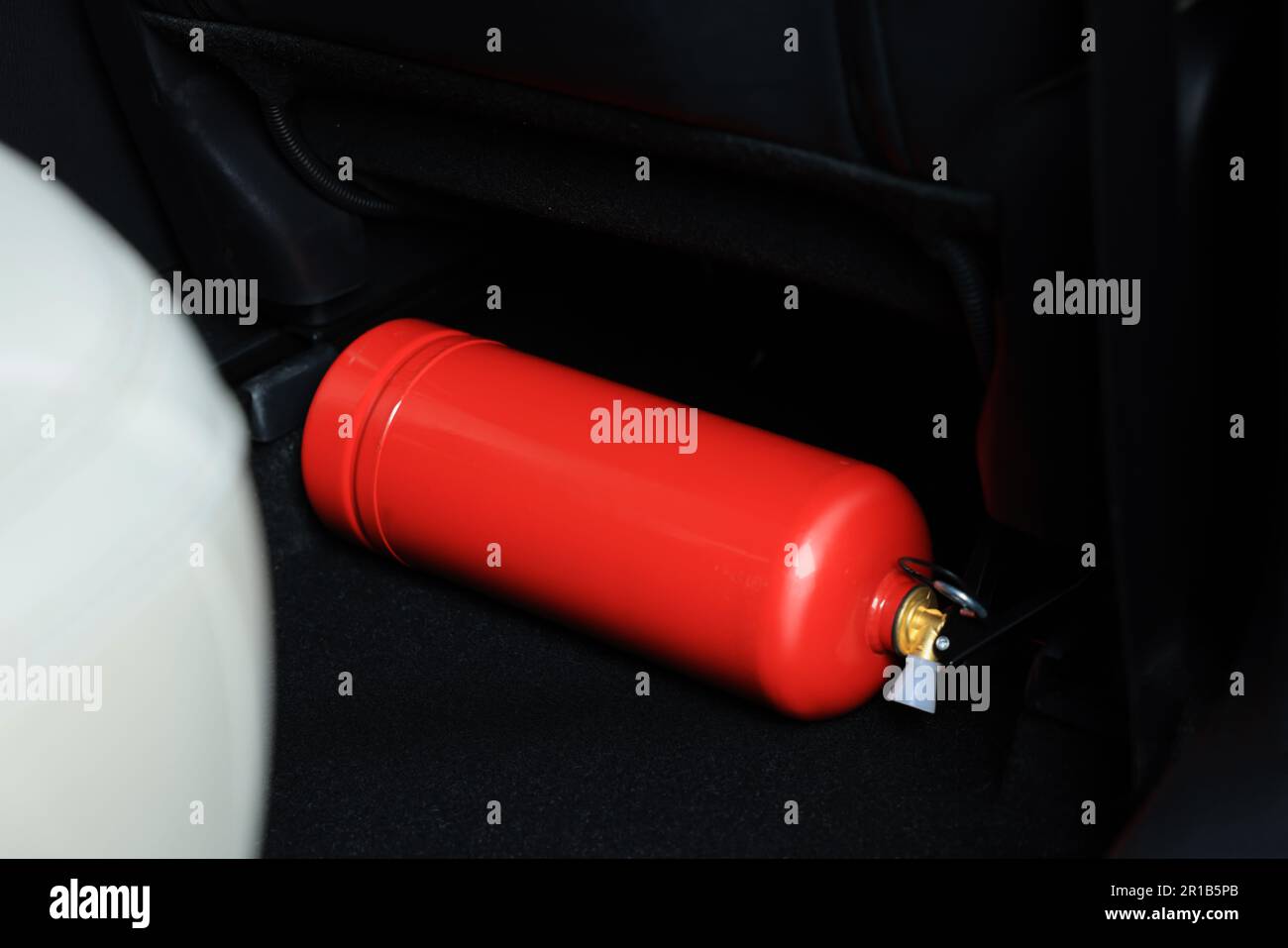 Red fire extinguisher in trunk. Car safety equipment Stock Photo - Alamy