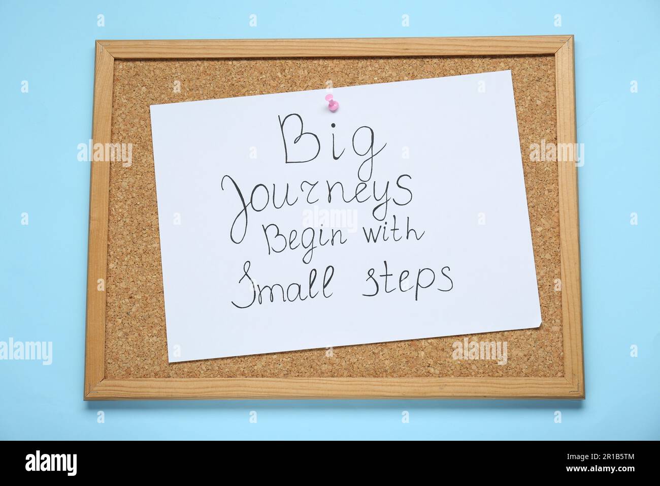 Corkboard with pinned message Big Journeys Begin With Small Steps on ...