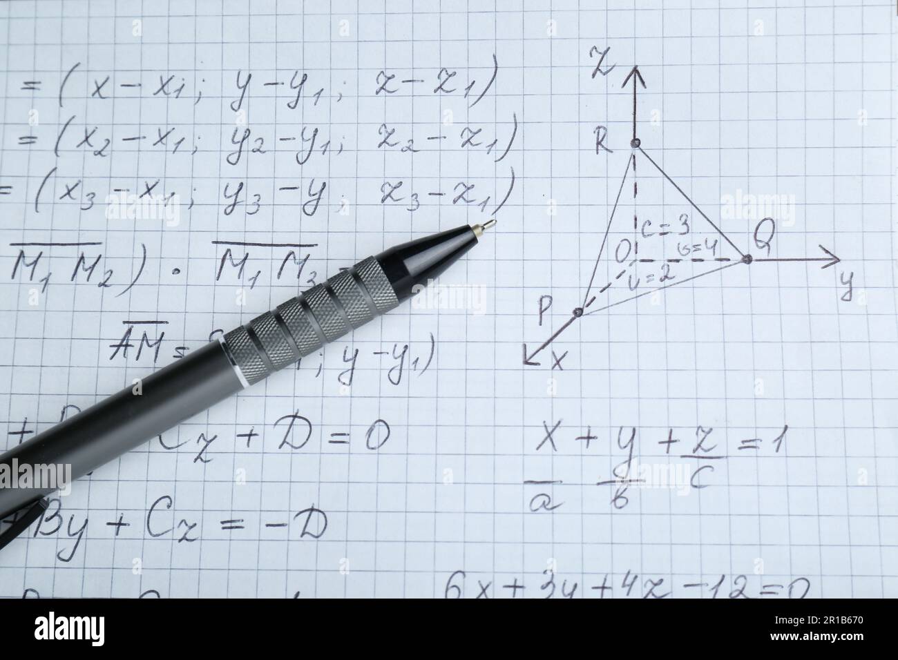 Sheet of paper with different mathematical formulas and pen, top view ...