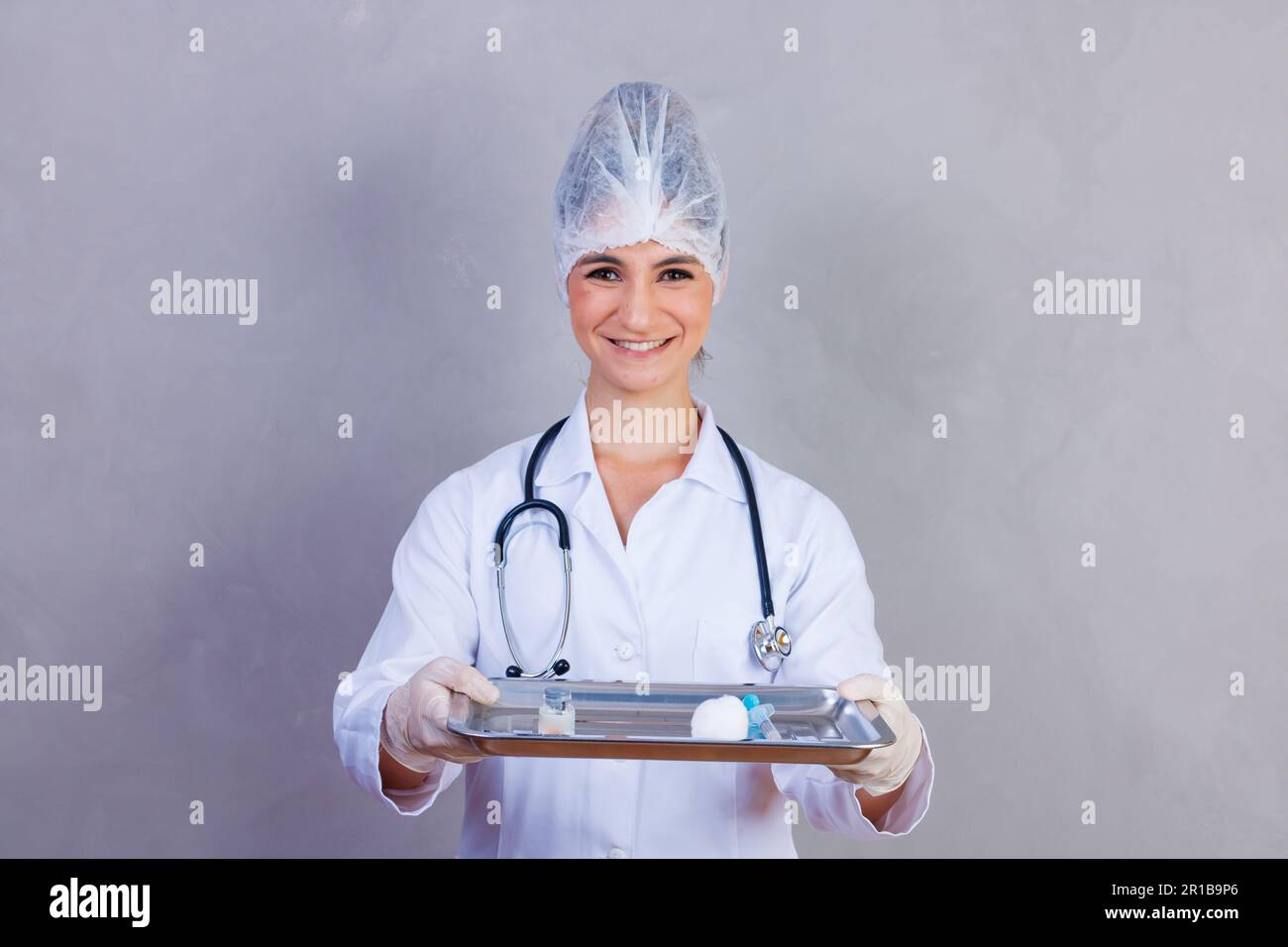 nurse holding tray with medicines on gray background. Doctors on gray ...