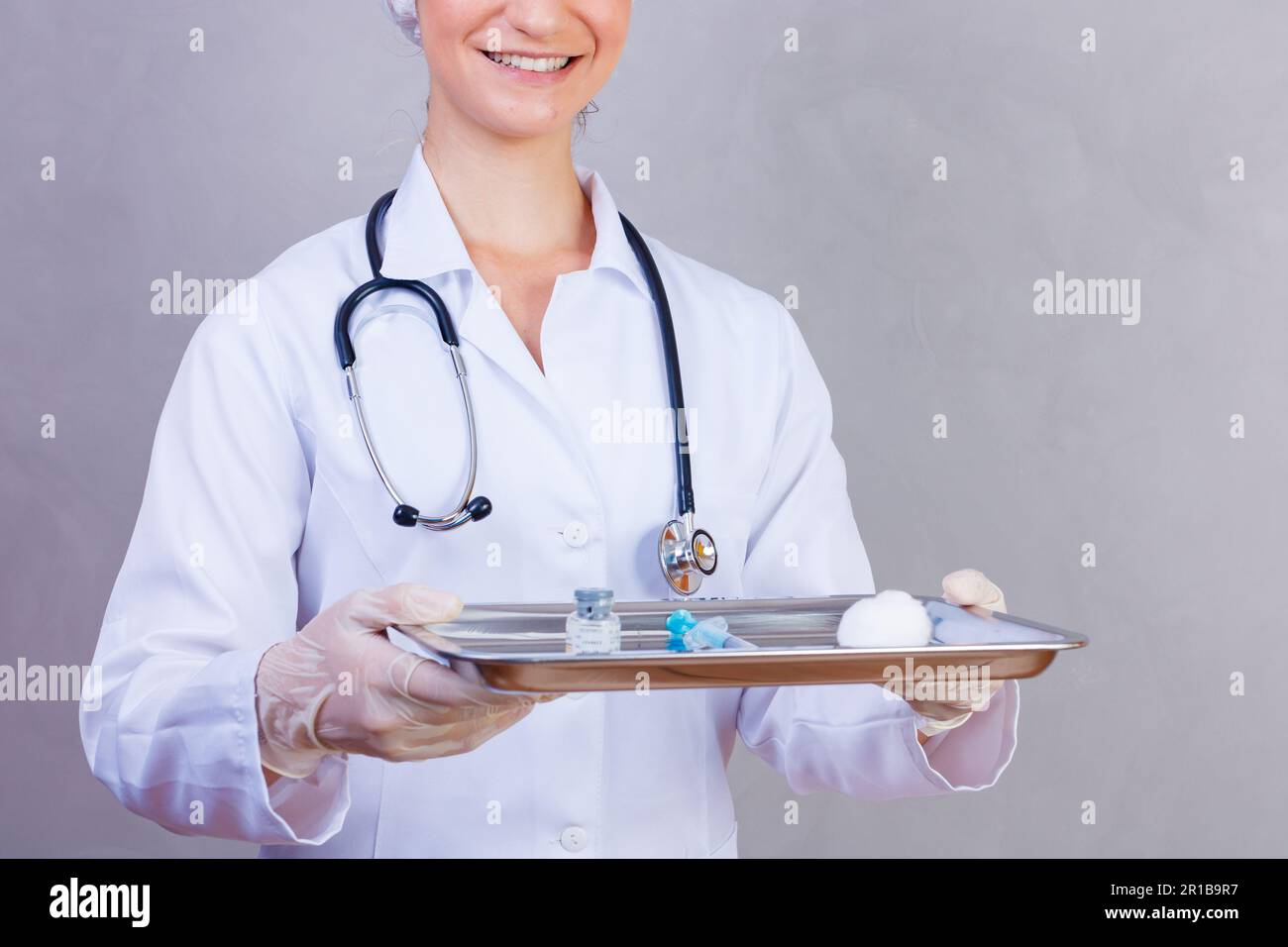 nurse holding tray with medicines on gray background. Doctors on gray ...