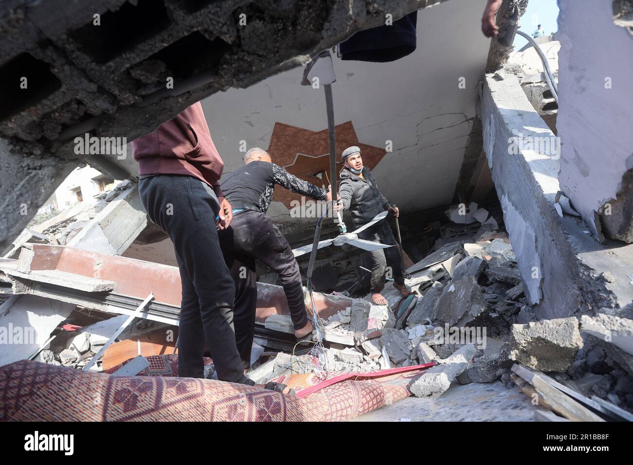 Palestinians inspect the rubble of a destroyed house of Islamic Jihad ...