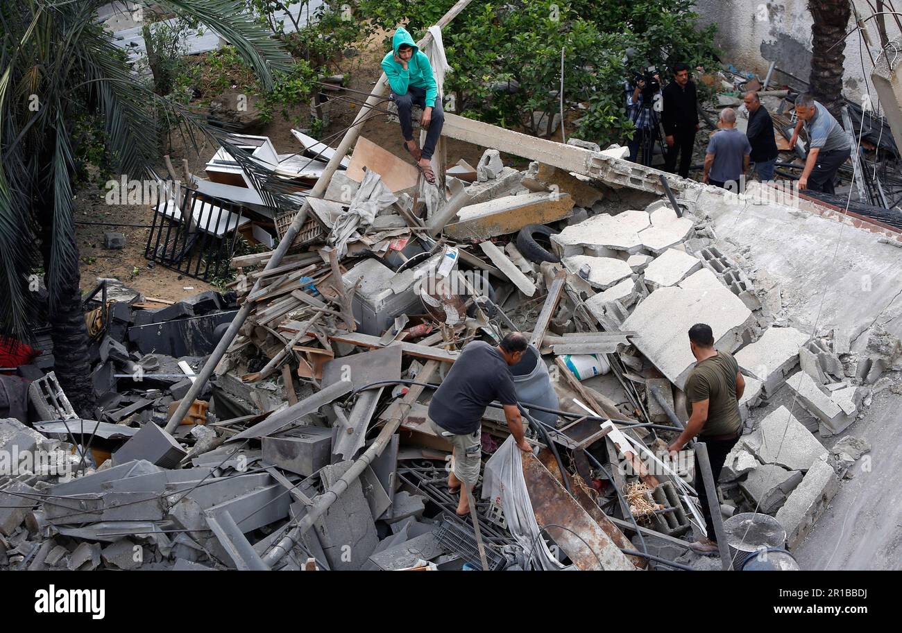 Palestinians inspect the rubble of a destroyed house of Islamic Jihad ...