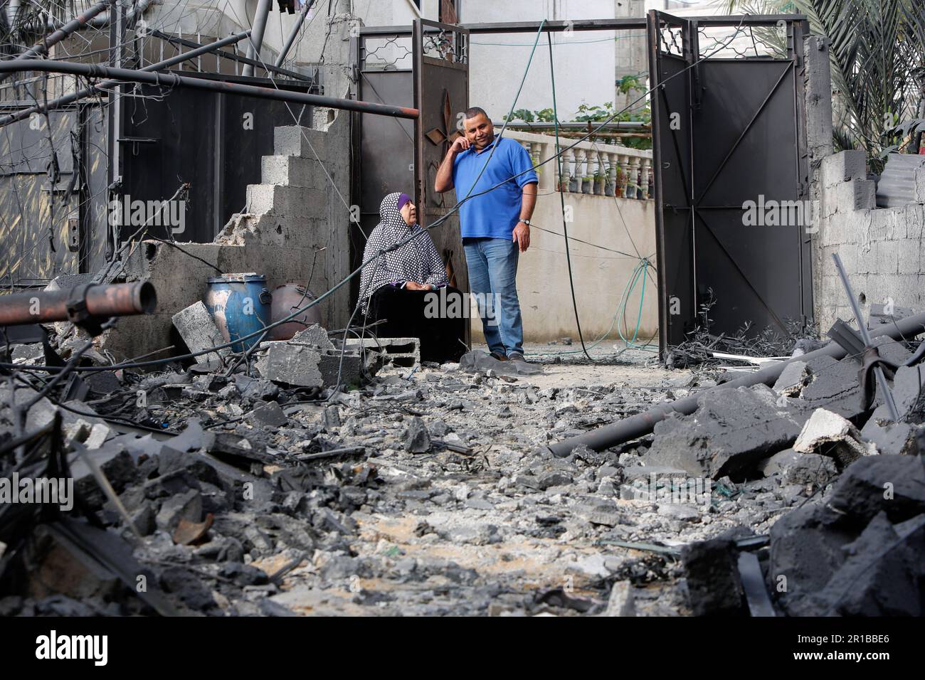 Palestinians inspect the rubble of a destroyed house of Islamic Jihad ...