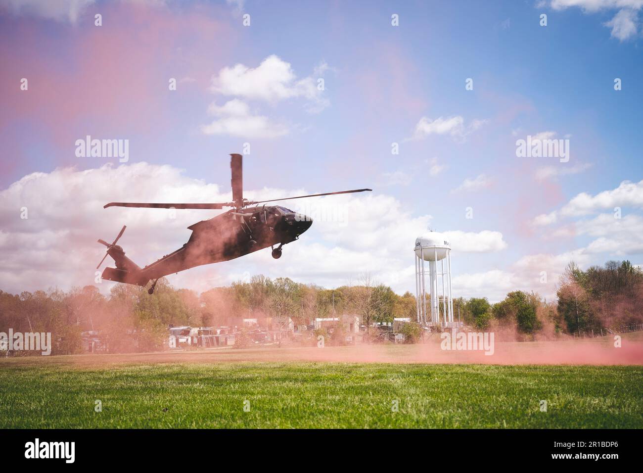 A smoke grenade is deployed to mark the landing zone for a UH-60 Black ...