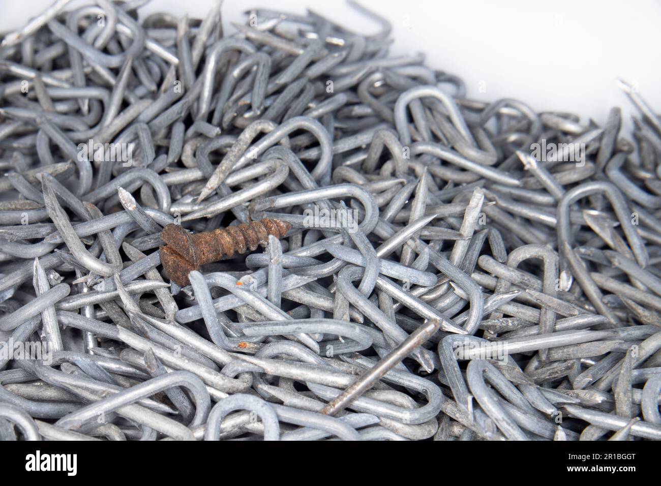 pile of heavy barbed wire staples for construction and carpentry Stock ...