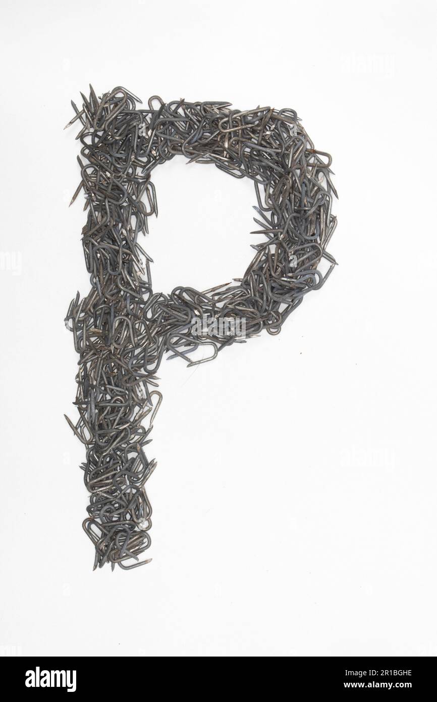 artistic isolated Letter P made from steel staples isolated on a white ...