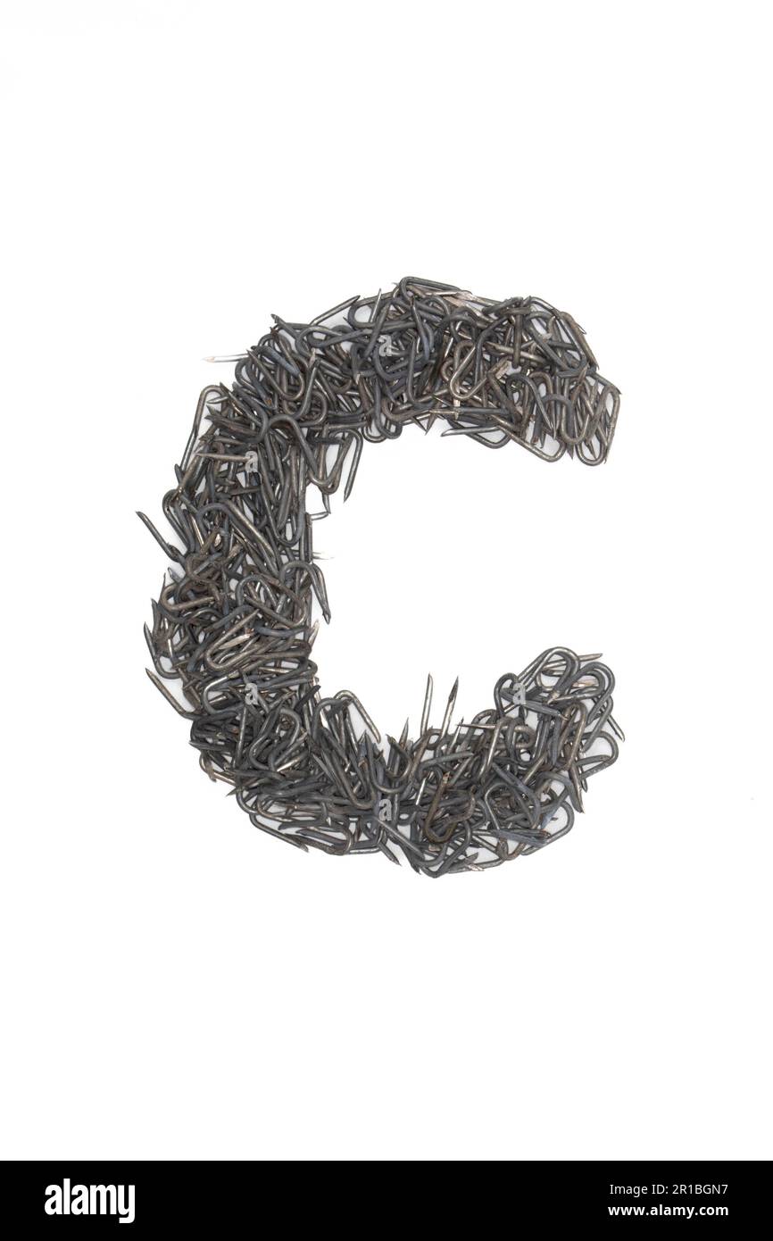 artistic isolated Letter C made from steel staples isolated on a white ...