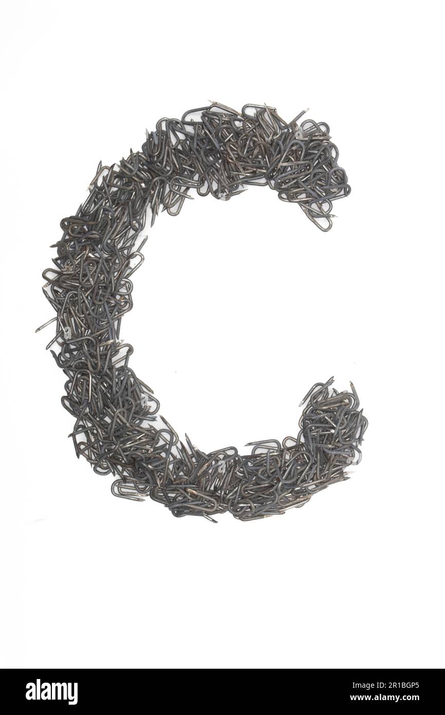 artistic isolated Letter C made from steel staples isolated on a white ...