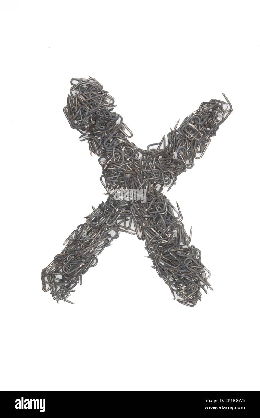 artistic isolated Letter X made from steel staples isolated on a white ...