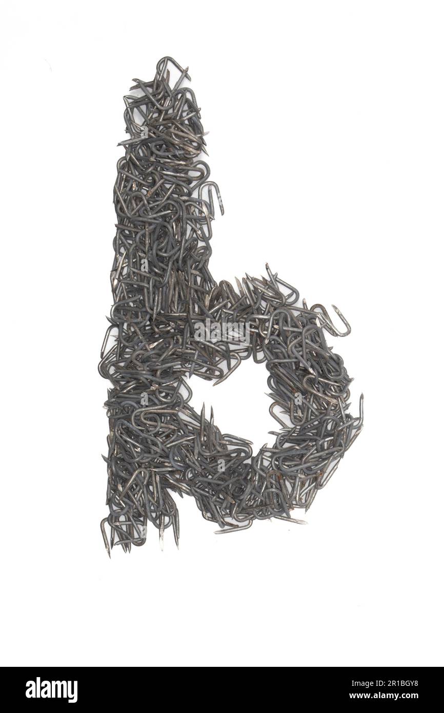 artistic isolated Letter b made from steel staples isolated on a white ...