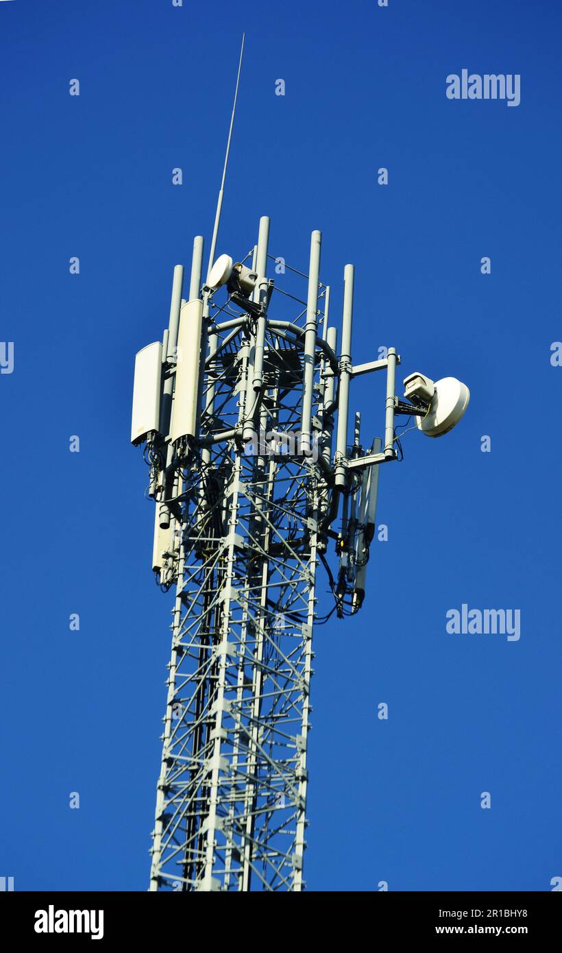 Cell phone tower over blue sky Stock Photo - Alamy